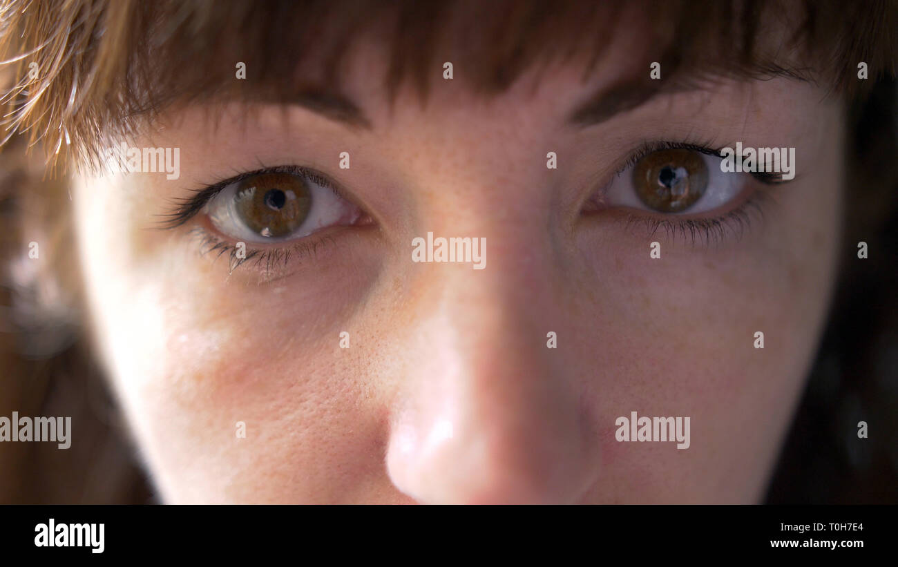 Portrait of a woman looking into the camera, close-up Stock Photo - Alamy