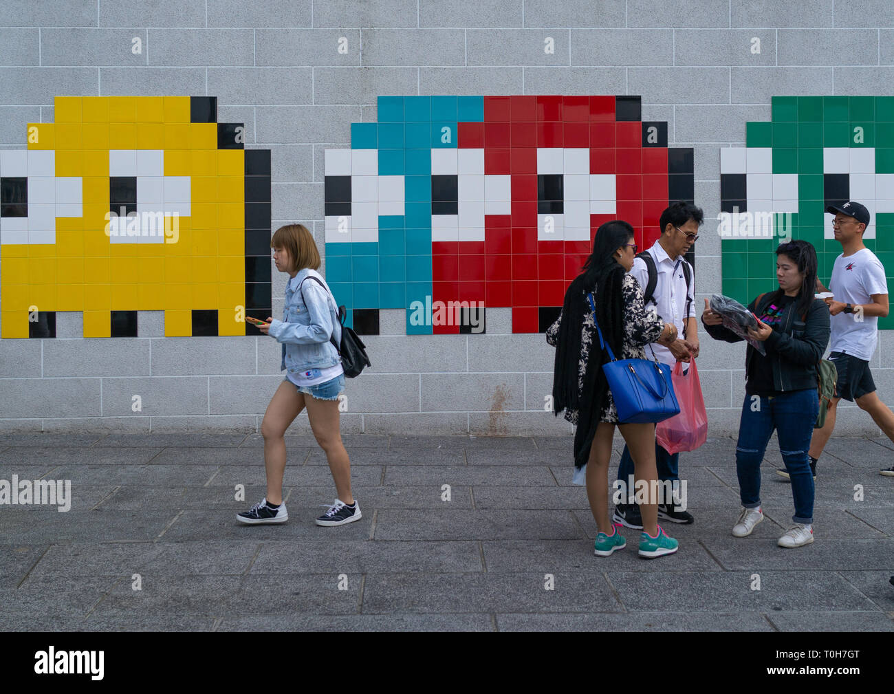 Invader pac-man mosaics on a wall in the street, Kowloon, Hong Kong ...