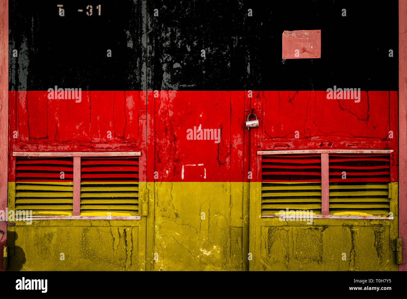 Close-up of old warehouse gate with national flag of Germany. Concept ...