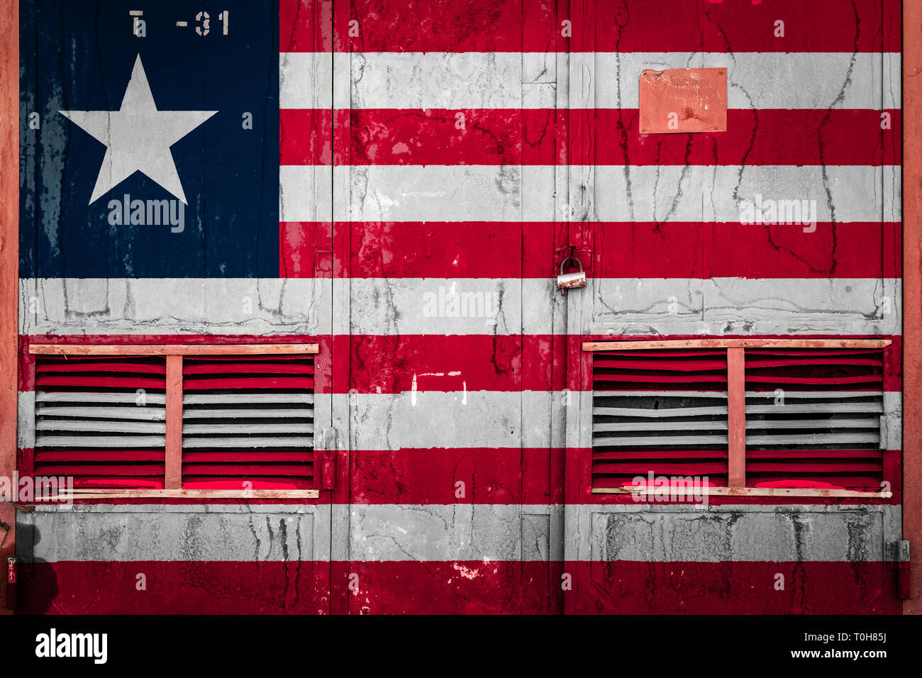 Close-up of old warehouse gate with national flag of Liberia. Concept ...