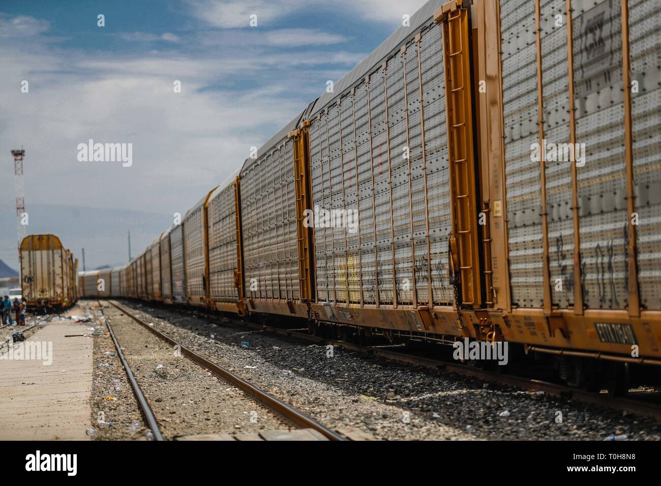 Train or Mexican railways passing through the popular colony in ...