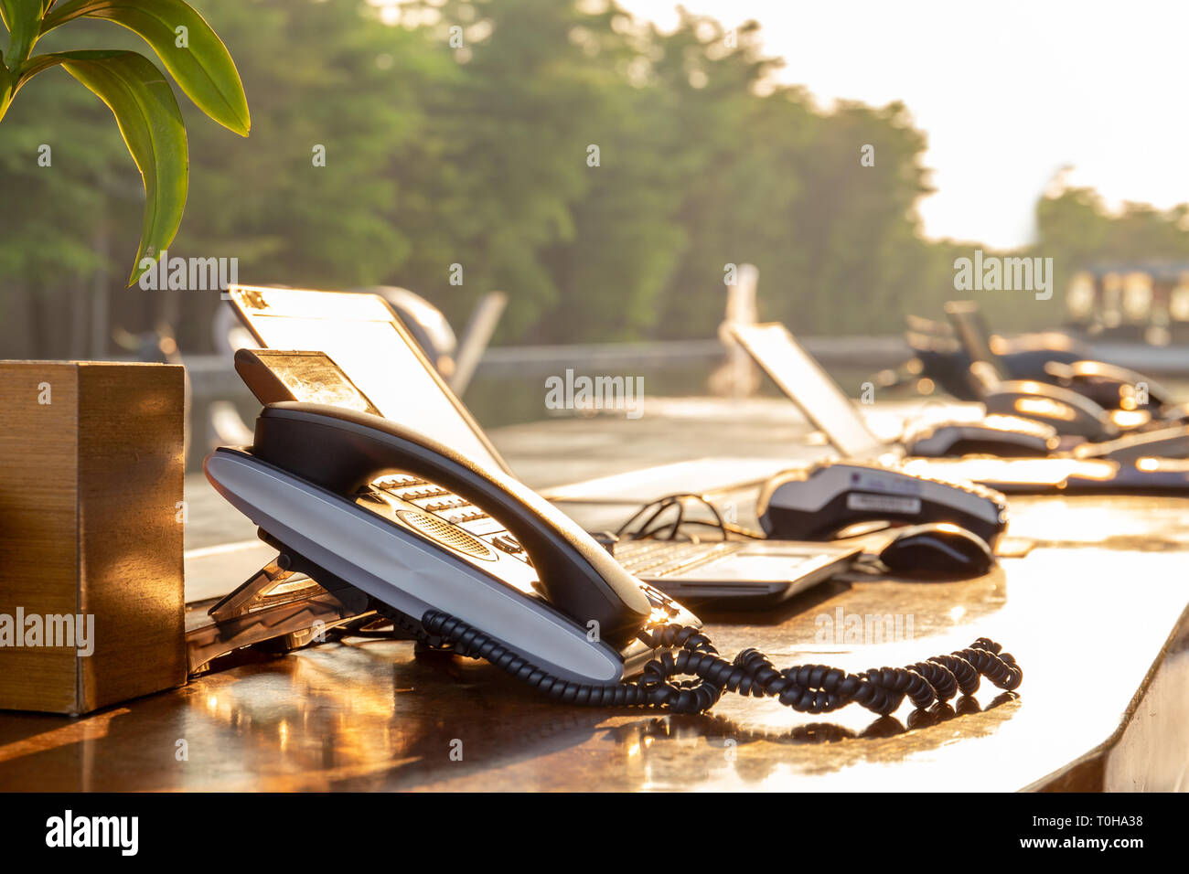 Telephone on wooden desk at hotel reception in blur background Stock ...