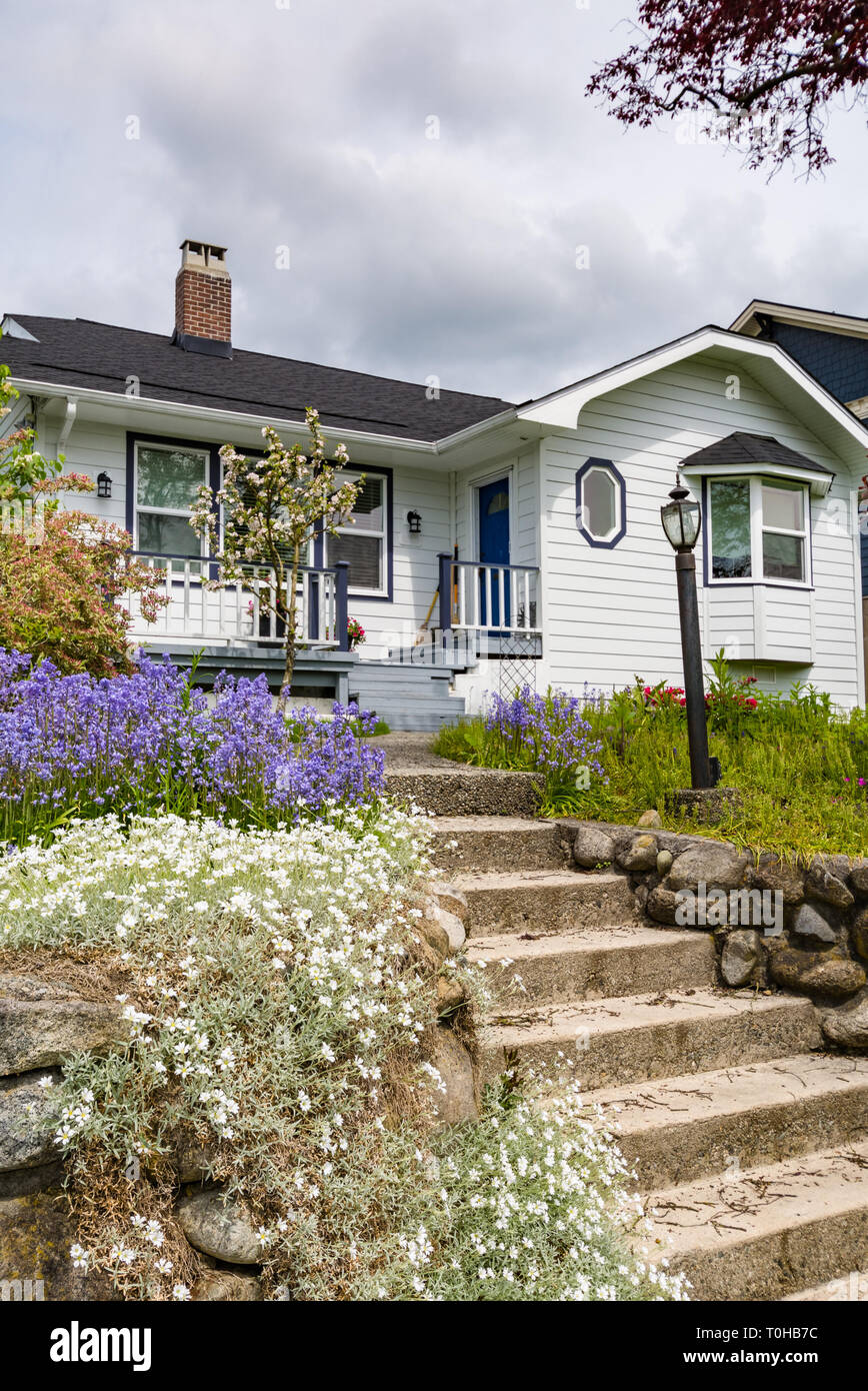 Concrete stairway to average residential house built on land terrace ...