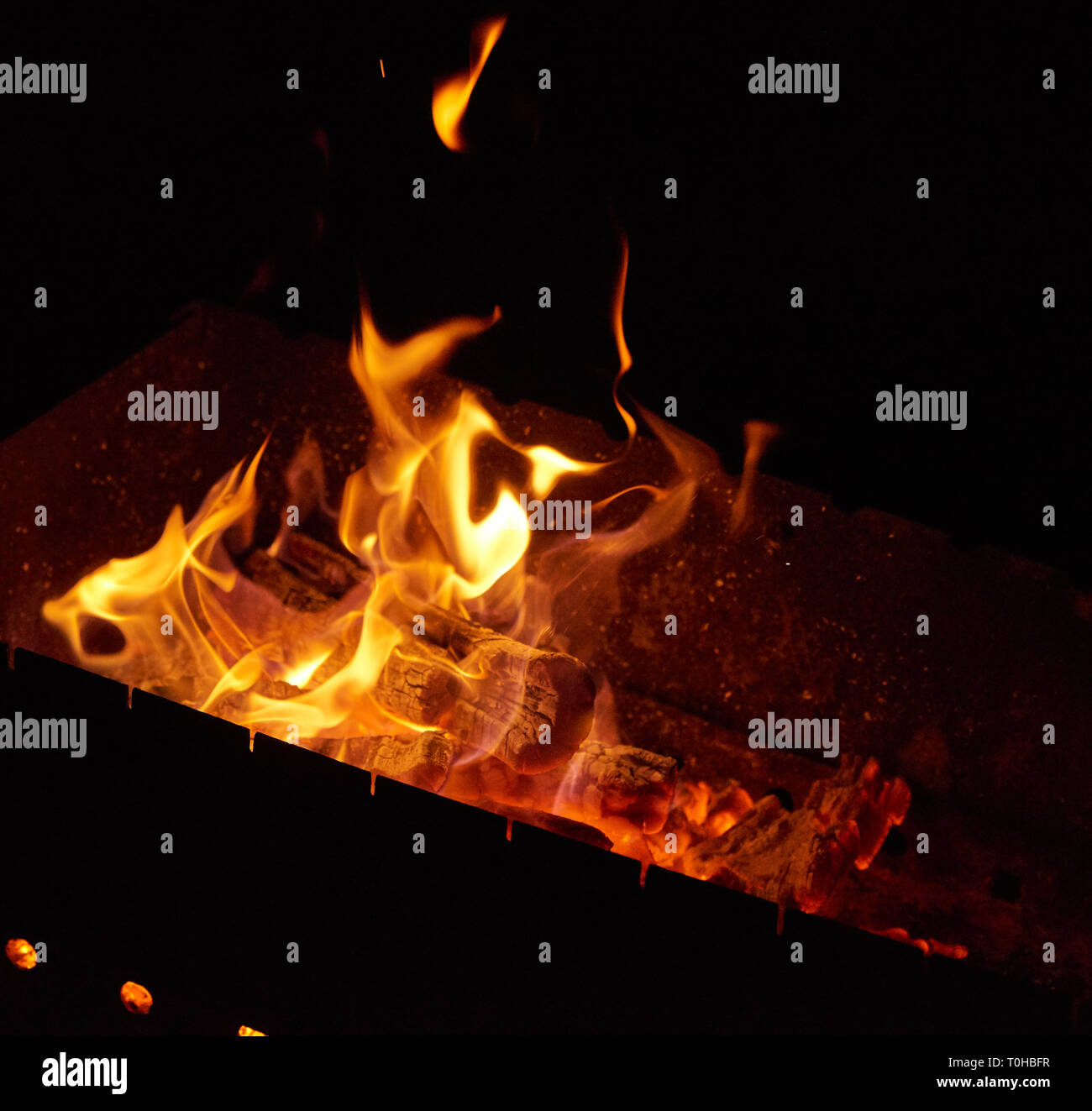 burning wooden logs in the fire at night, black background Stock Photo ...