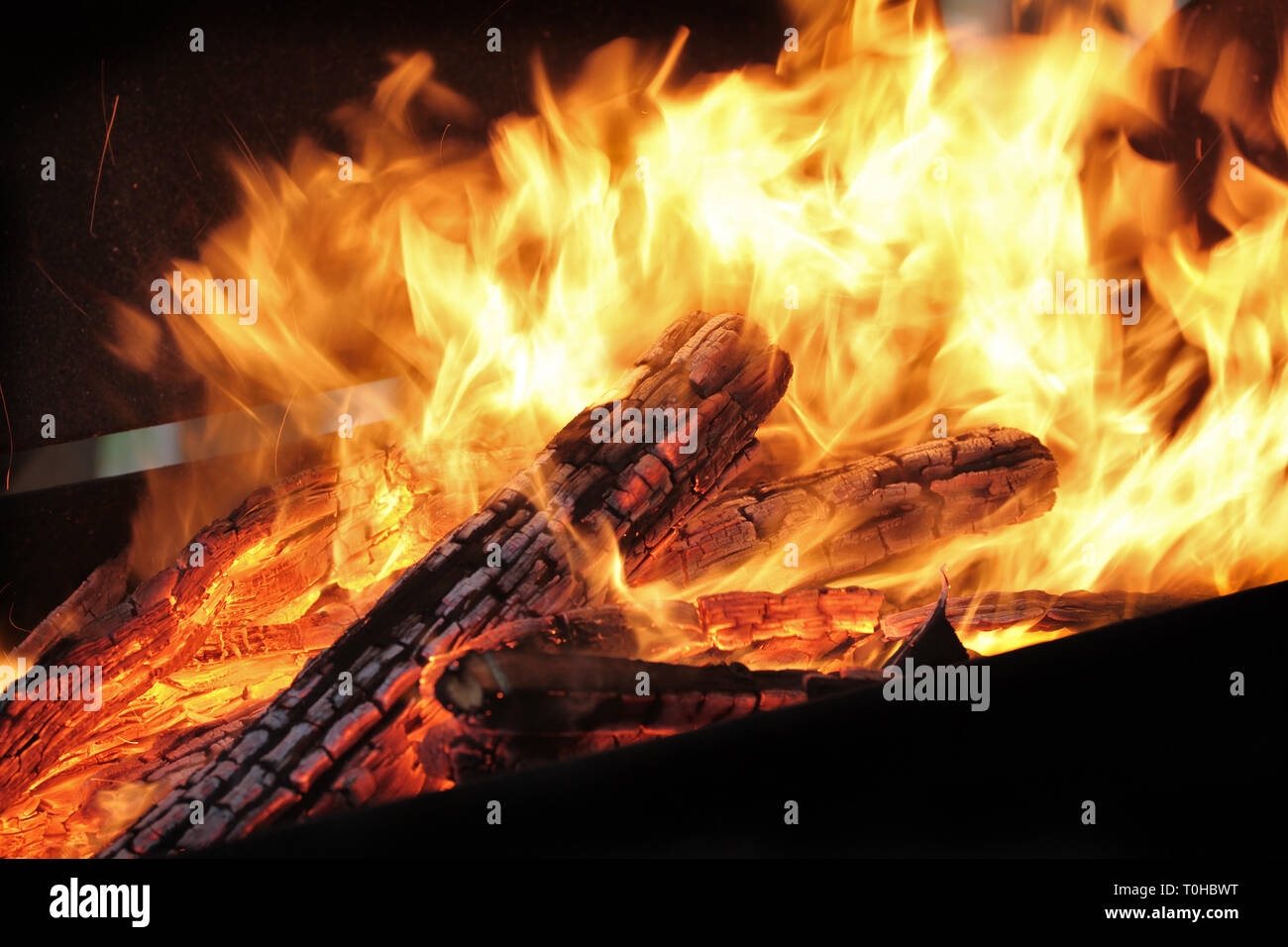 A shot of burning firewood in the fireplace. Close-up. Burning wood for ...