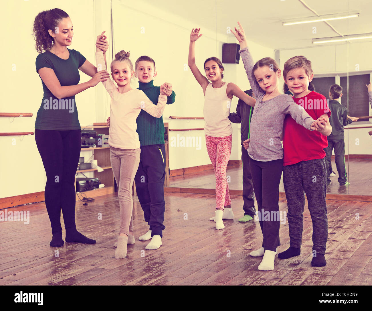 Group of positive children dancing samba in dance studio Stock Photo ...