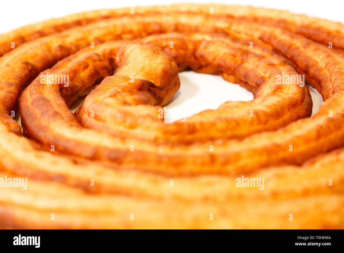 Big spanish fritter dough placed spirally Stock Photo - Alamy