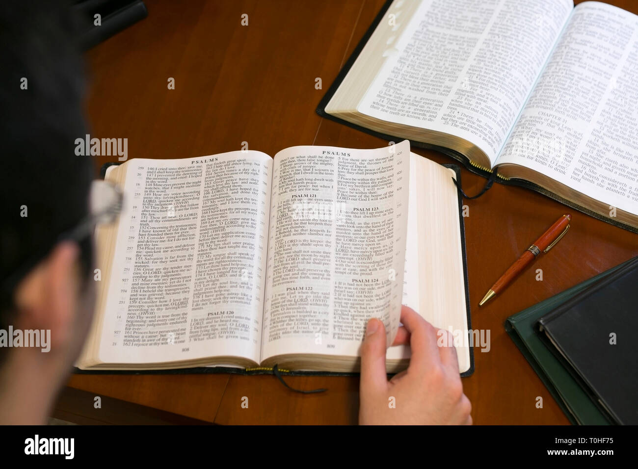 Man studying and comparing books Stock Photo - Alamy