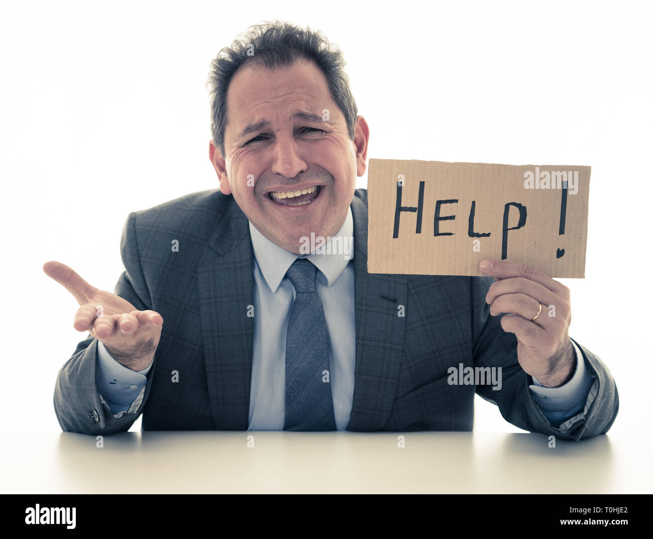 Stressed and desperate middle aged caucasian businessman holding a help ...