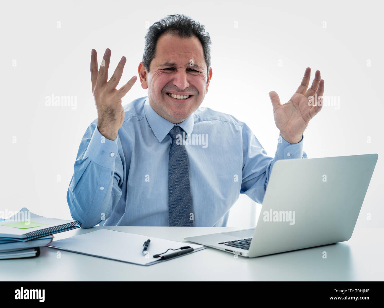 Angry and frustrated middle aged businessman overworked at desk upset ...