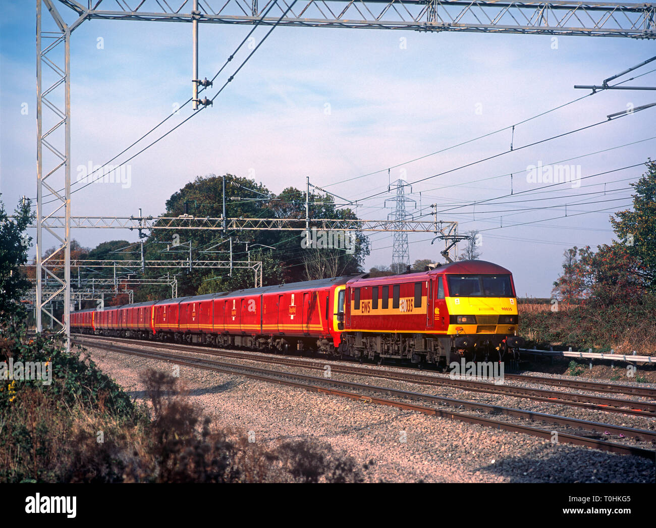 A class 90 electric locomotive number 90035 with three class 325 mail ...