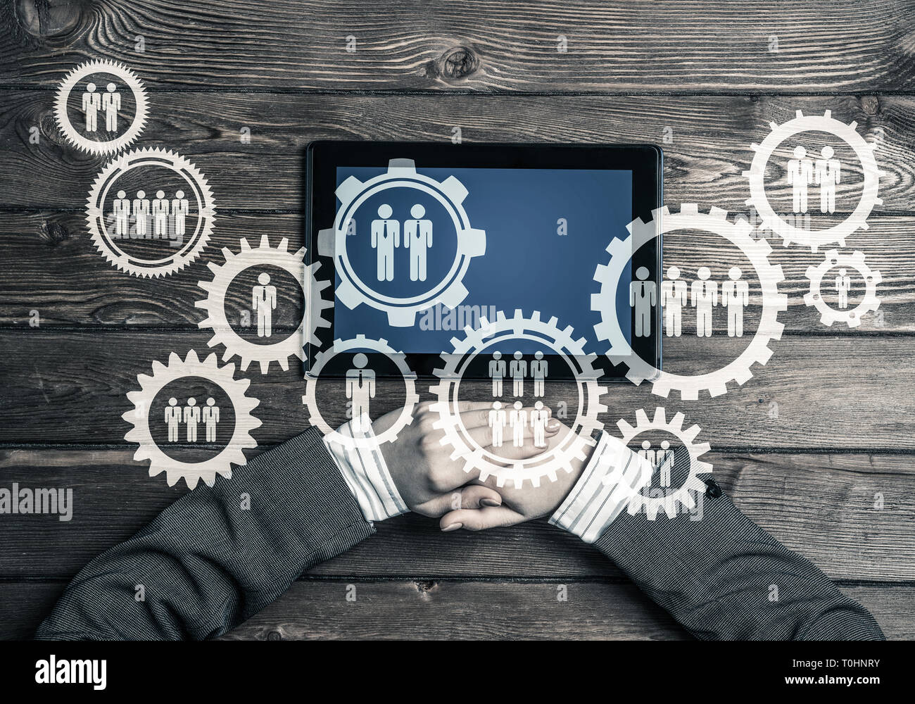 Concept of teamworking and connection with gears mechanism and tablet ...