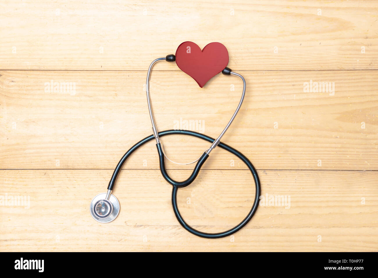 Stethoscope and red heart on the wooden table. Health day concept Stock ...
