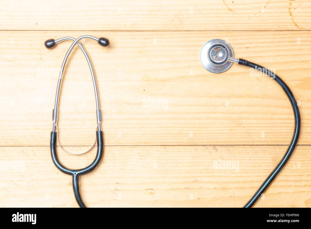 Stethoscope on the wooden table. Health day concept Stock Photo - Alamy