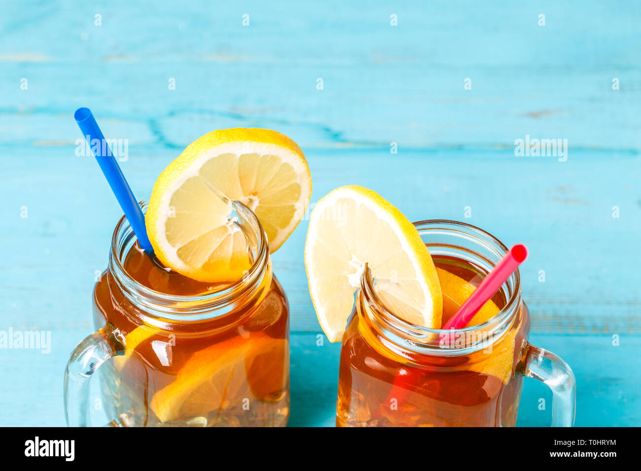Iced tea in a glass jar with lemon Stock Photo - Alamy