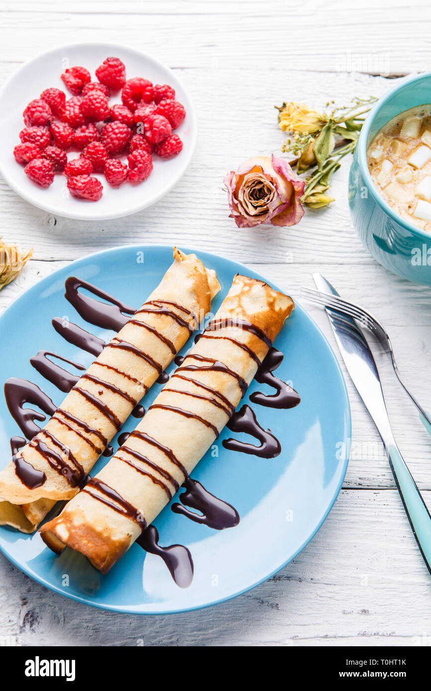 Homemade pancakes or russian blini with chocolate sauce on plate on ...