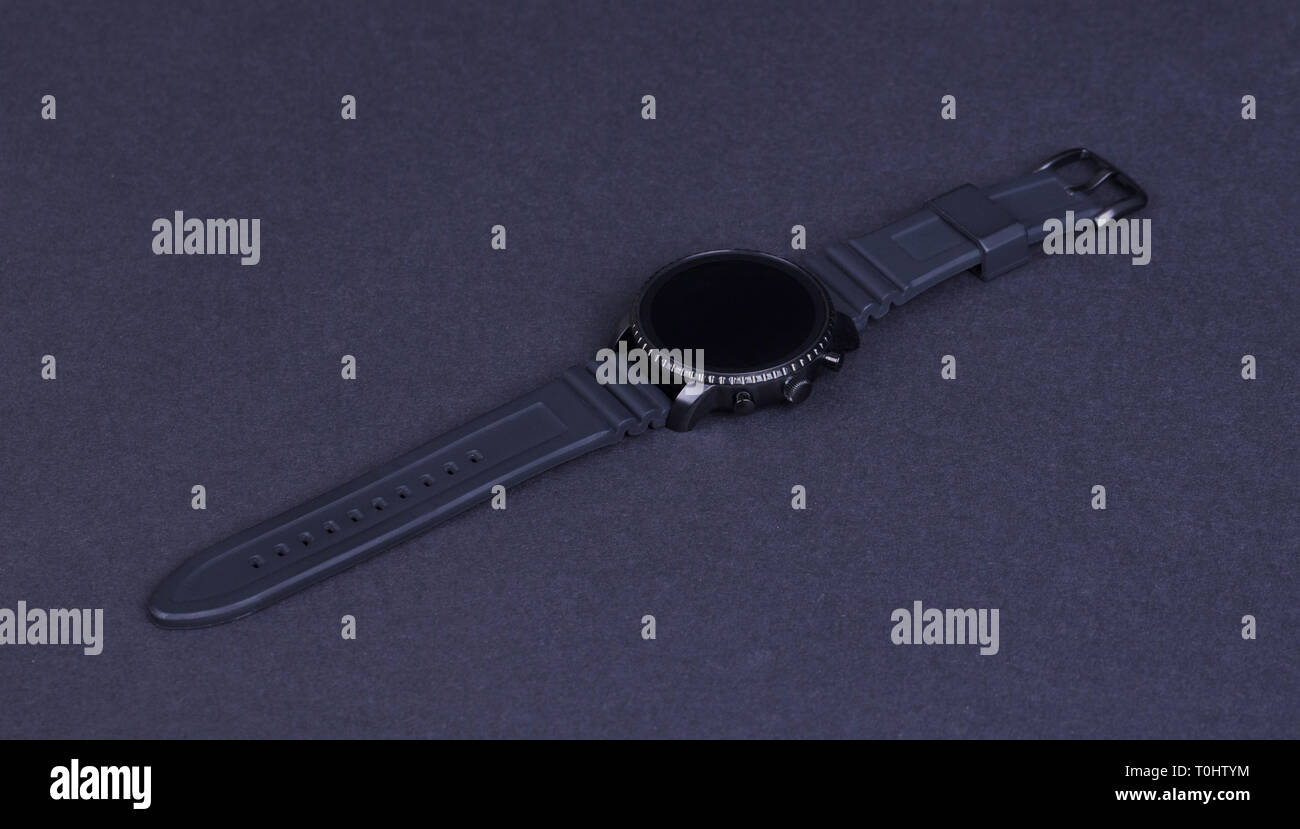 Black smartwatch isolated on a black background Stock Photo - Alamy