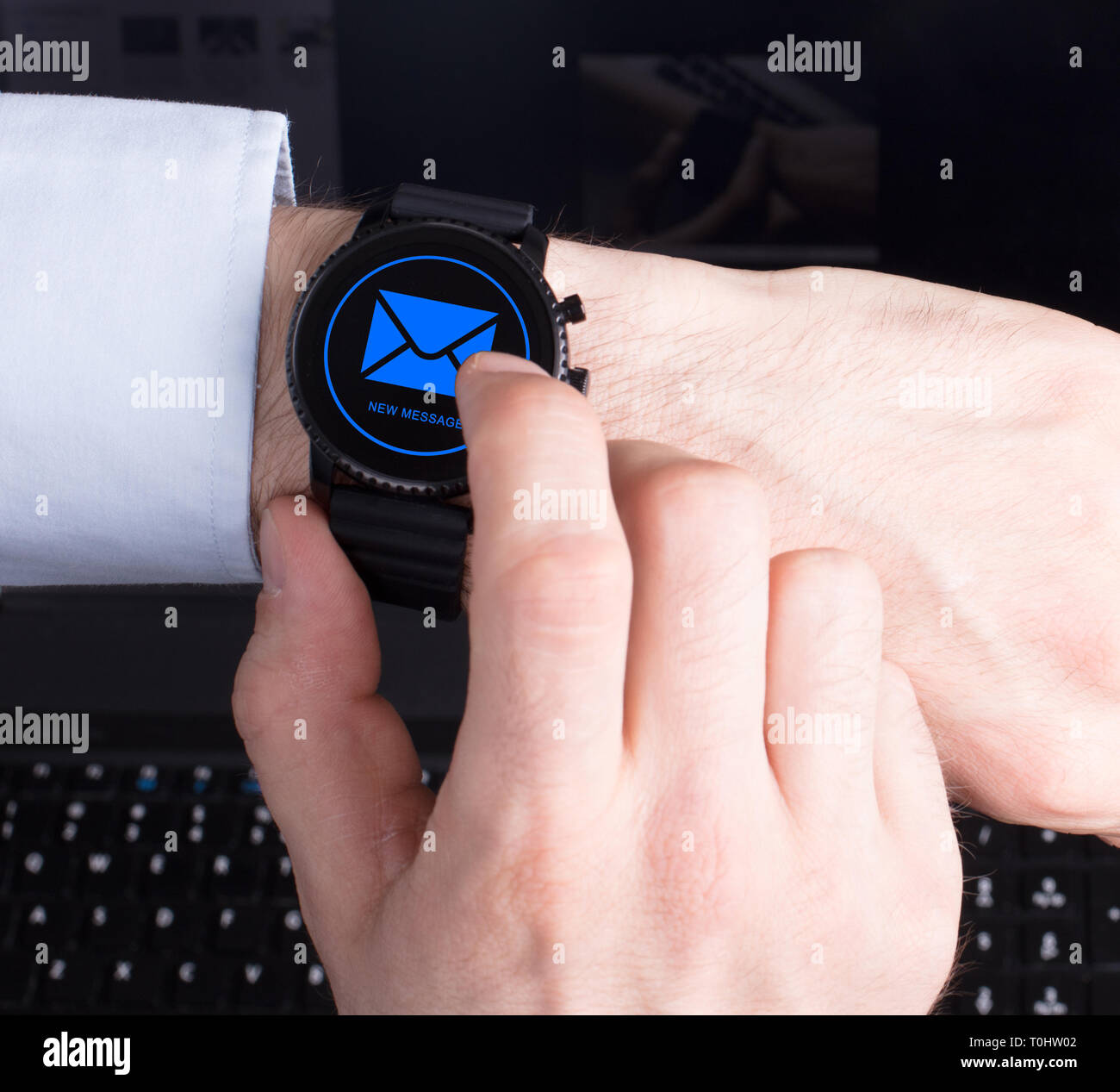 Black smartwatch isolated on a black background, new message Stock ...