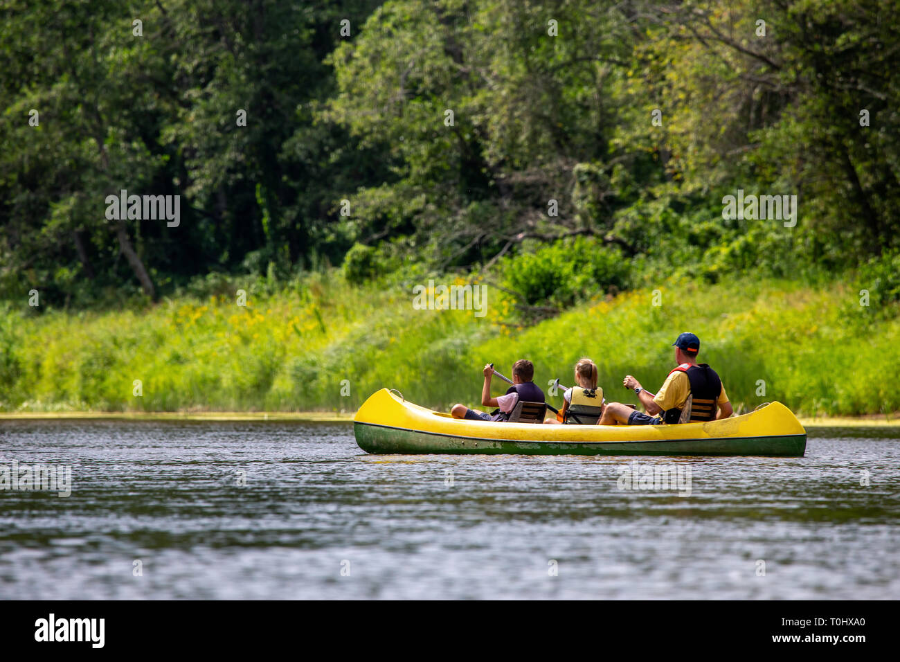 Family in yellow kayak drives on the river. People boating on river ...