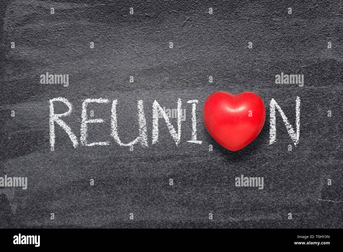 reunion word handwritten on chalkboard with red heart symbol instead of ...