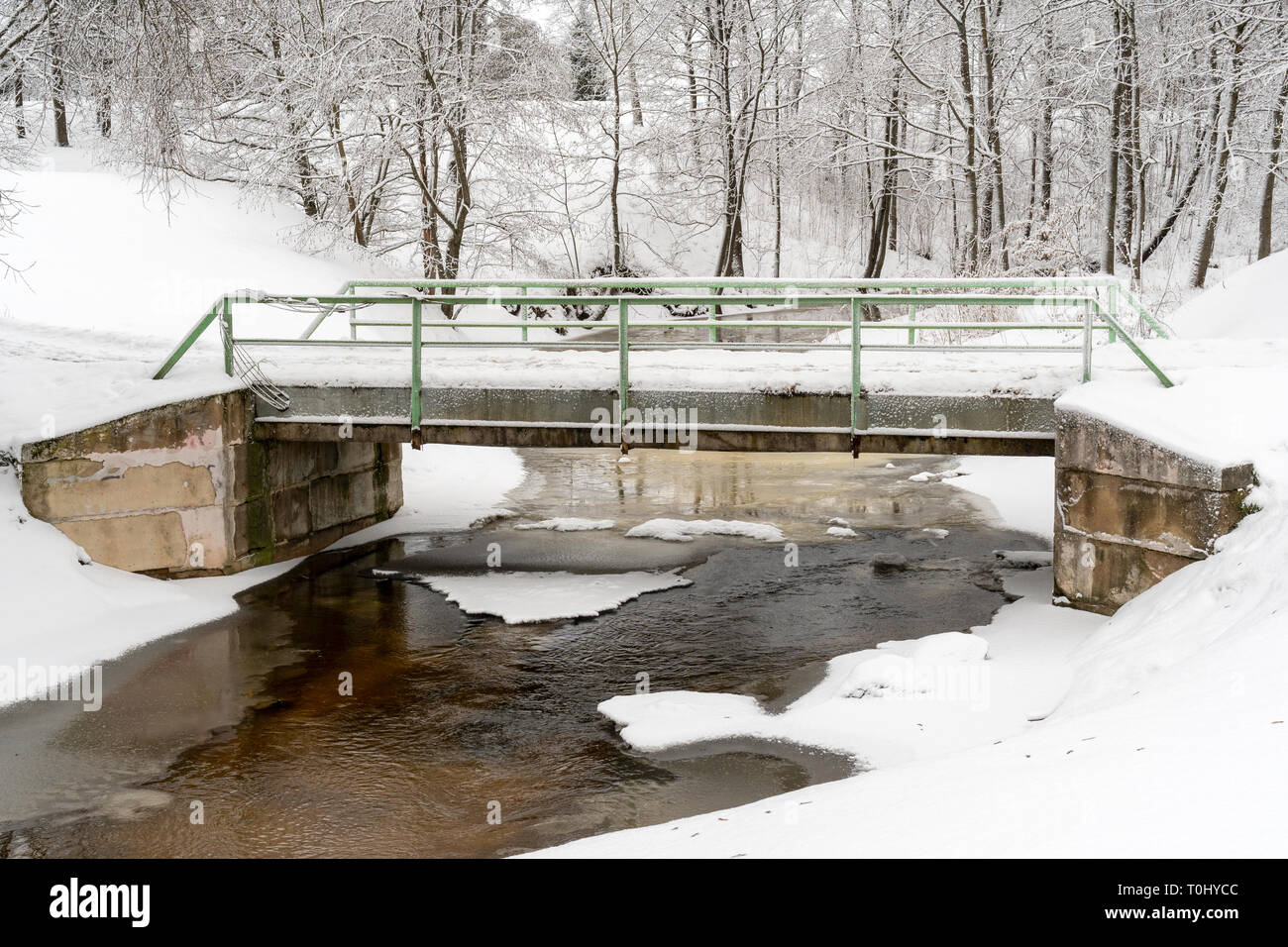 Small bridge over winter river in the park Stock Photo - Alamy