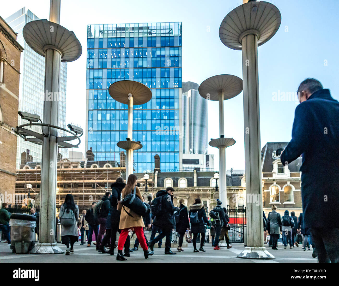 Early morning Commuters walking past very tall exterior sculptural ...