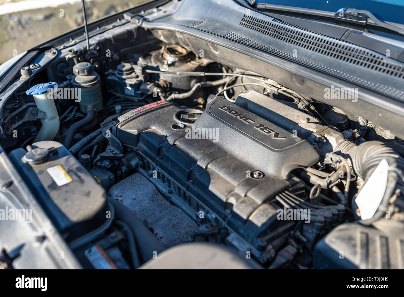 Dirty engine compartment in the used car, visible parts of the engine ...