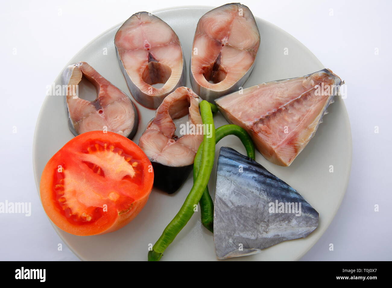 Chopped raw fish in plate, on white background Stock Photo - Alamy