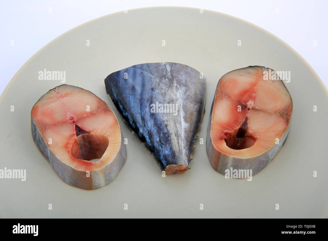 Chopped raw fish in plate, on white background Stock Photo - Alamy