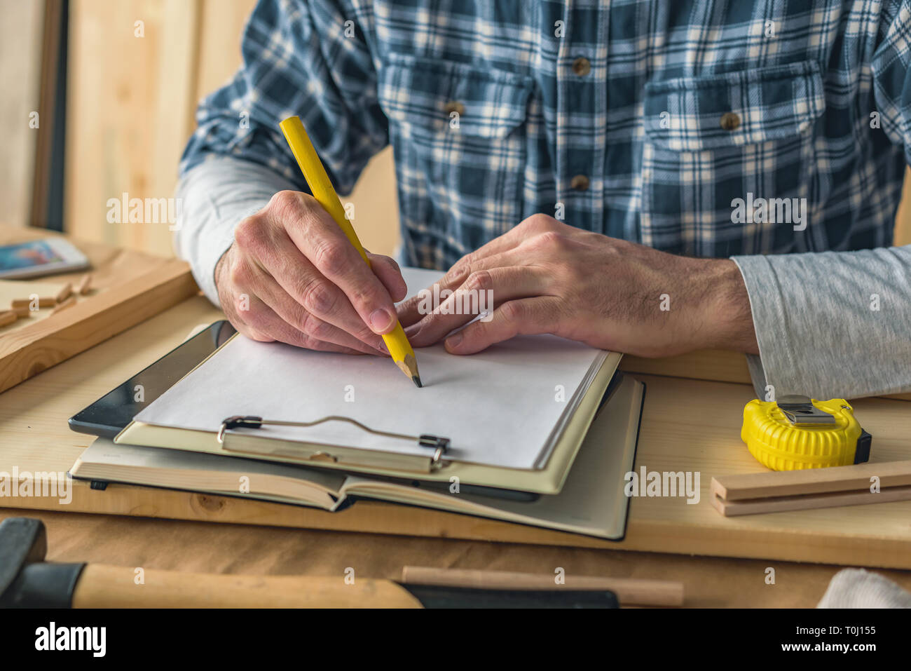 Carpenter writing clipboard notepad paper project notes and to do list ...