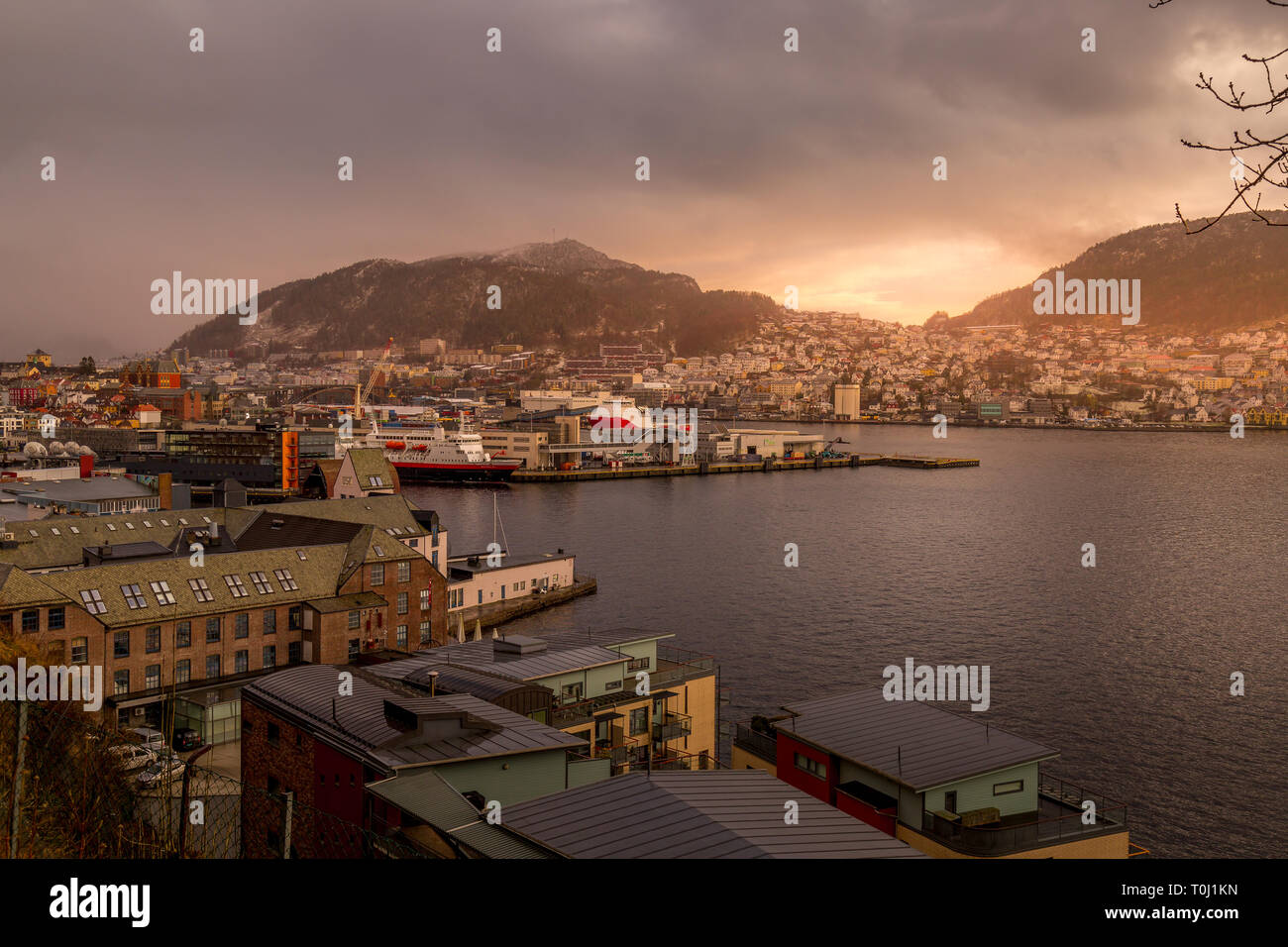 The sea port of Bergen in Norway, in early evening winter sun light ...