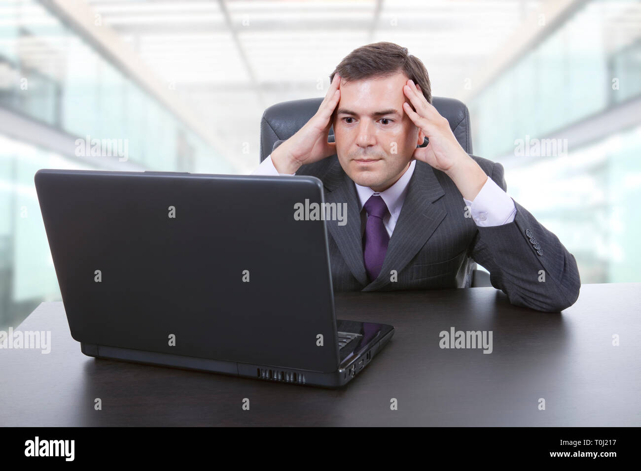 worried business man working with is laptop at the office Stock Photo ...