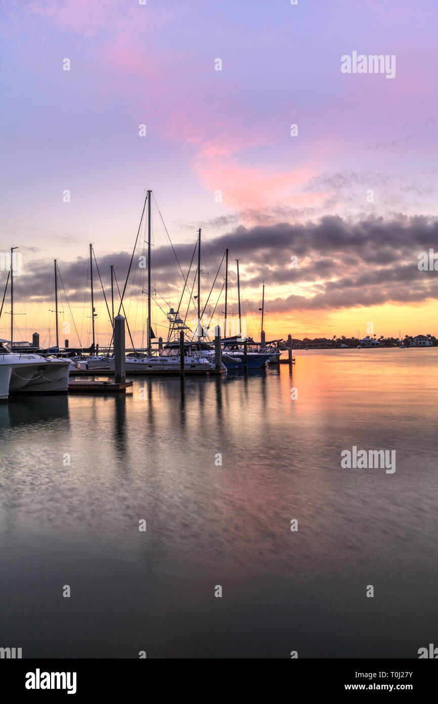 Break of dawn sunrise over boats and sailboats at Factory Bay marina in ...