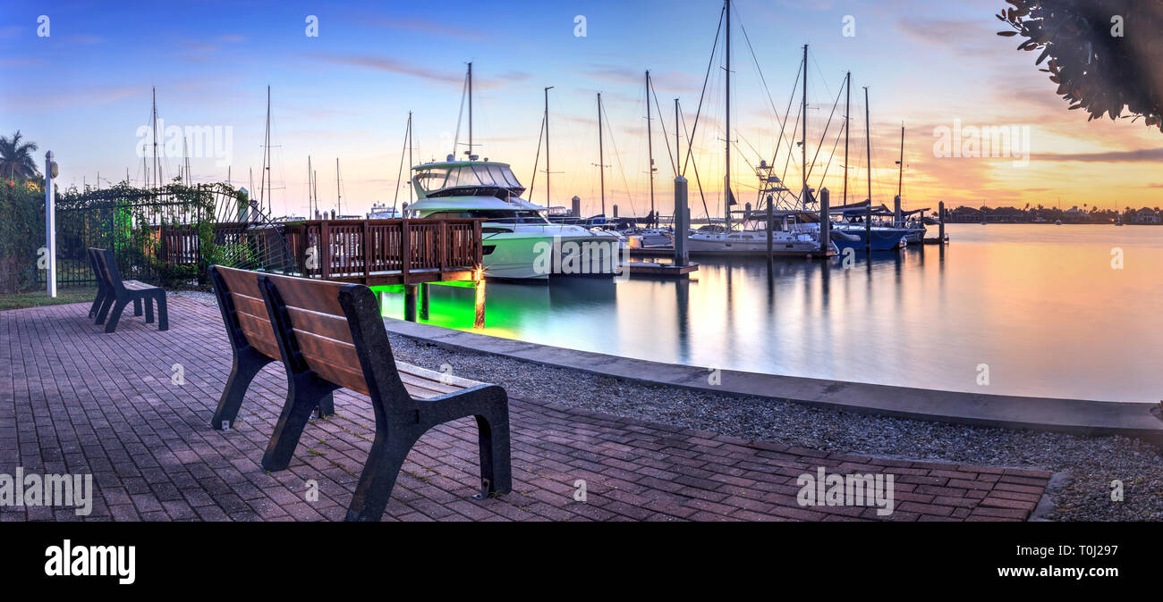 Break of dawn sunrise over boats and sailboats at Factory Bay marina in ...