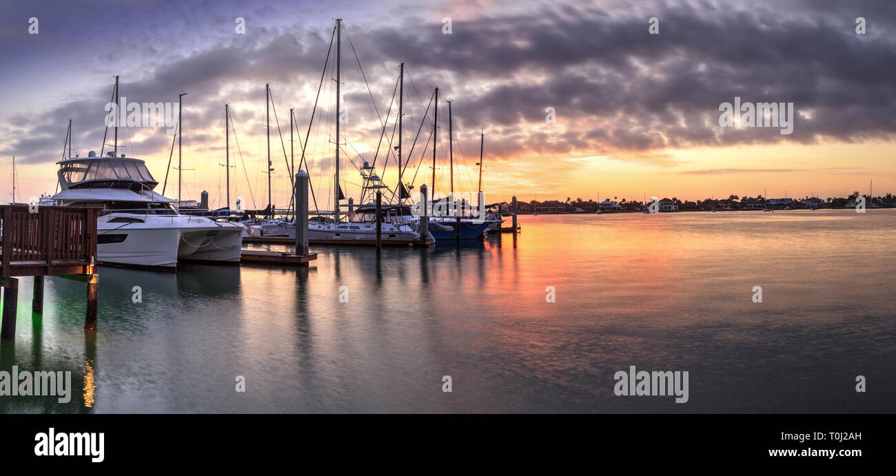 Break of dawn sunrise over boats and sailboats at Factory Bay marina in ...