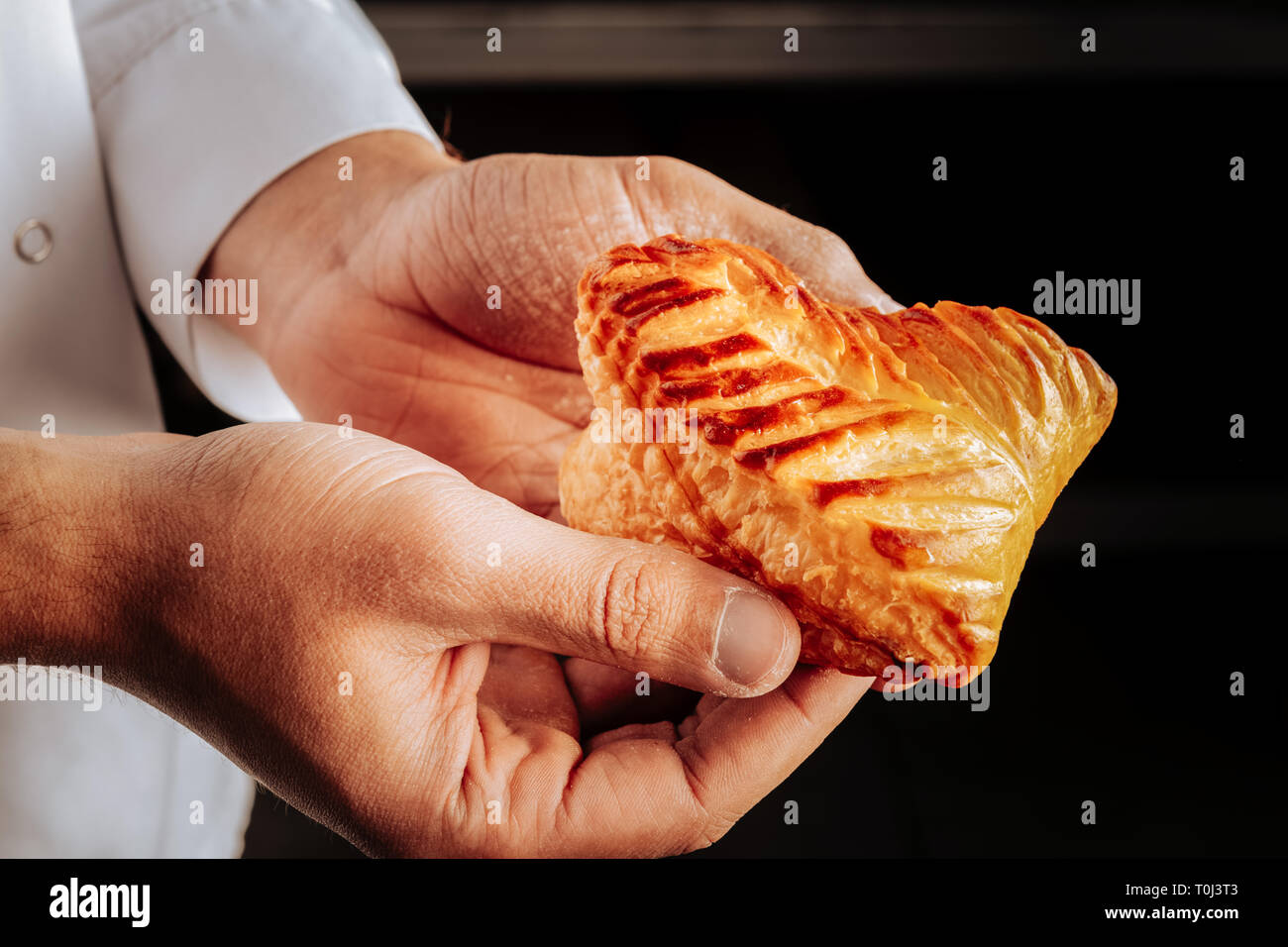 Professional baker holding nice yummy puff pastry Stock Photo - Alamy