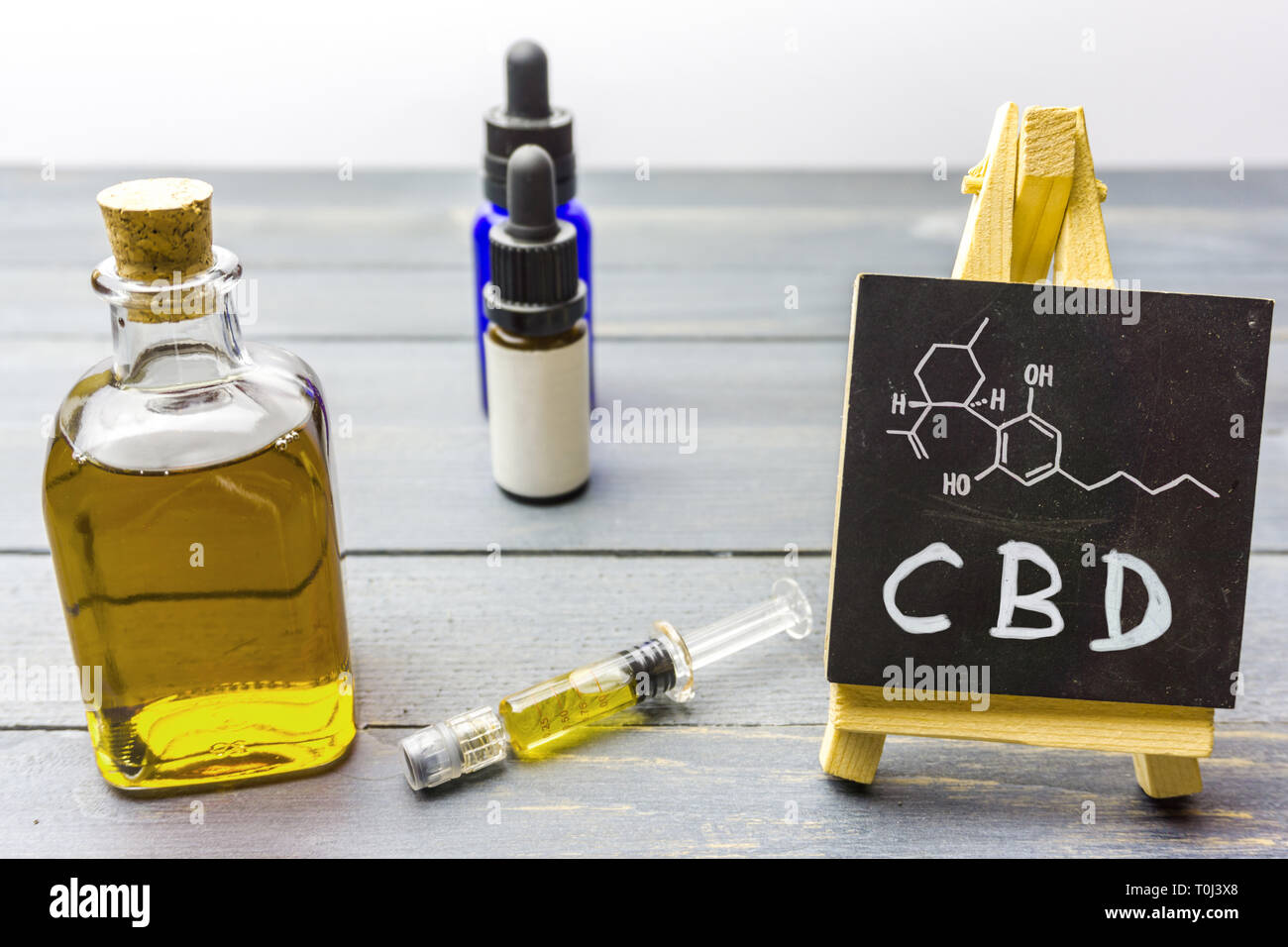 Cbd oil in glass bottle, hemp paste and chalkboard with molecule ...