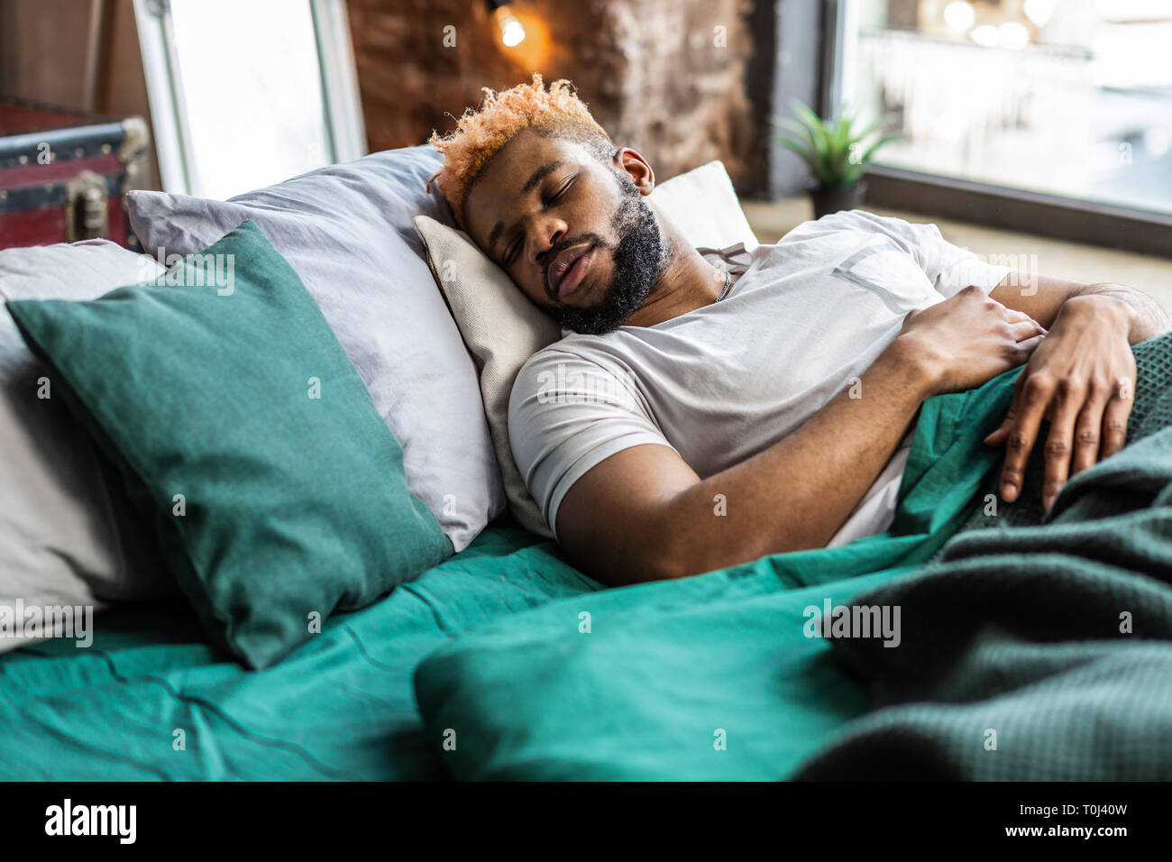 Nice peaceful man sleeping on his bed Stock Photo - Alamy