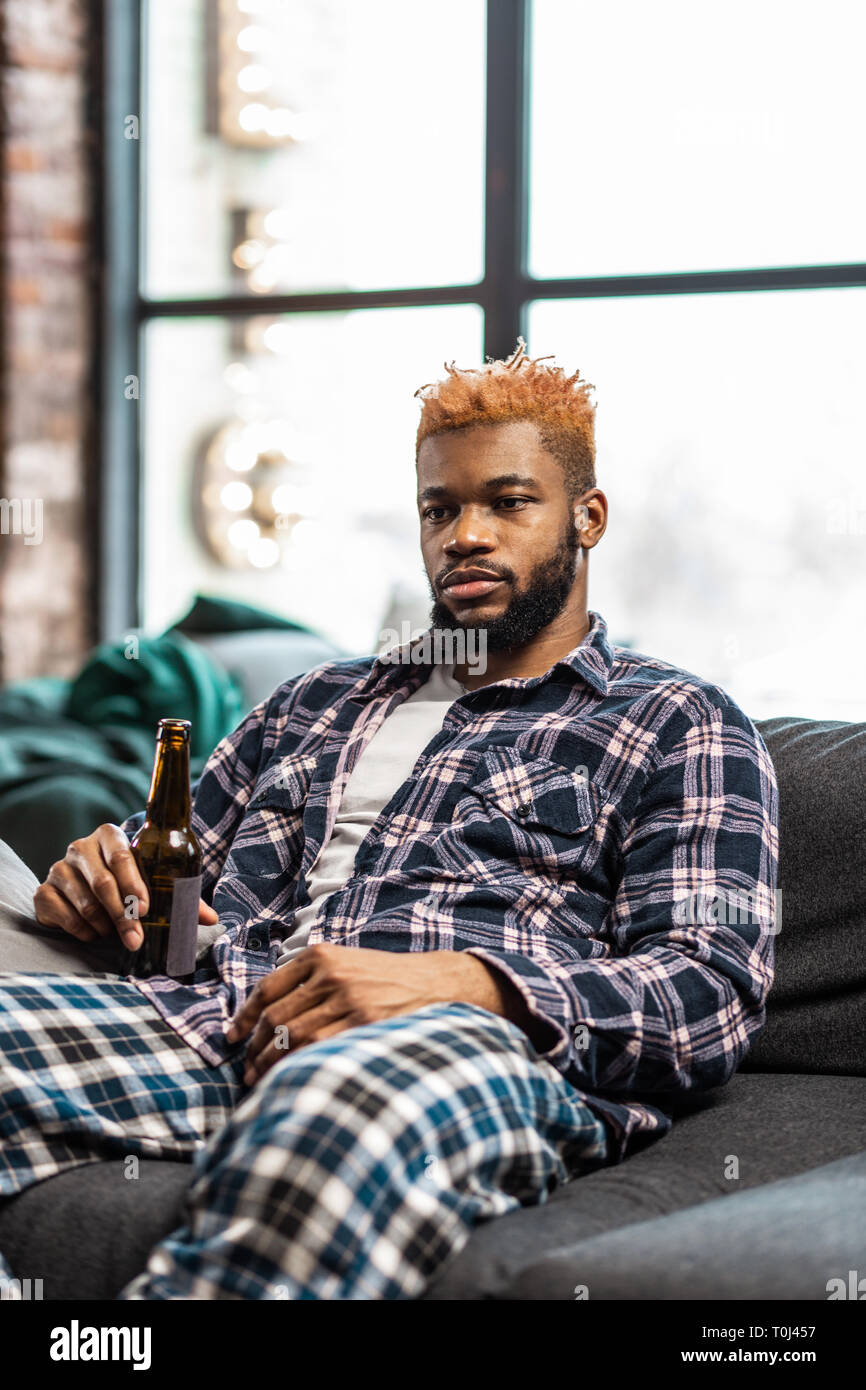 Sad gloomy man drinking beer at home Stock Photo - Alamy