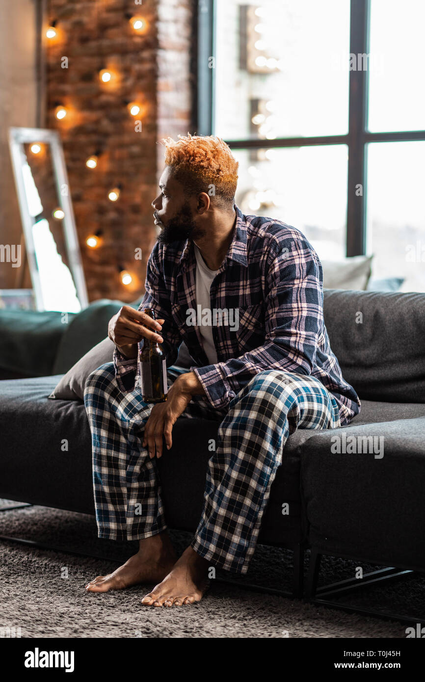 Nice young man looking into the window Stock Photo - Alamy