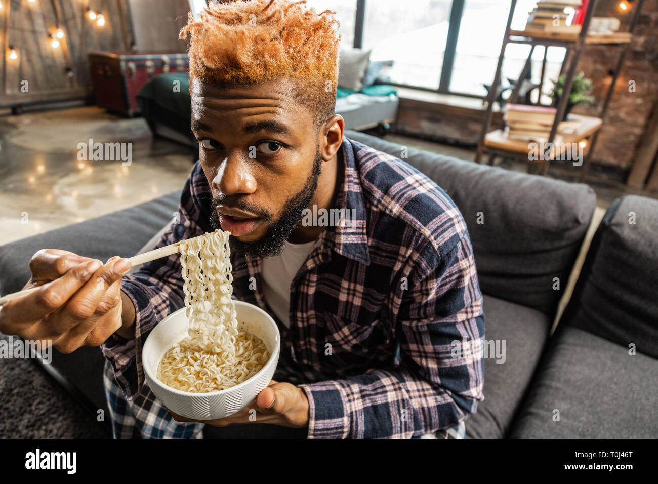 Top view of a nice hungry man eating Stock Photo - Alamy
