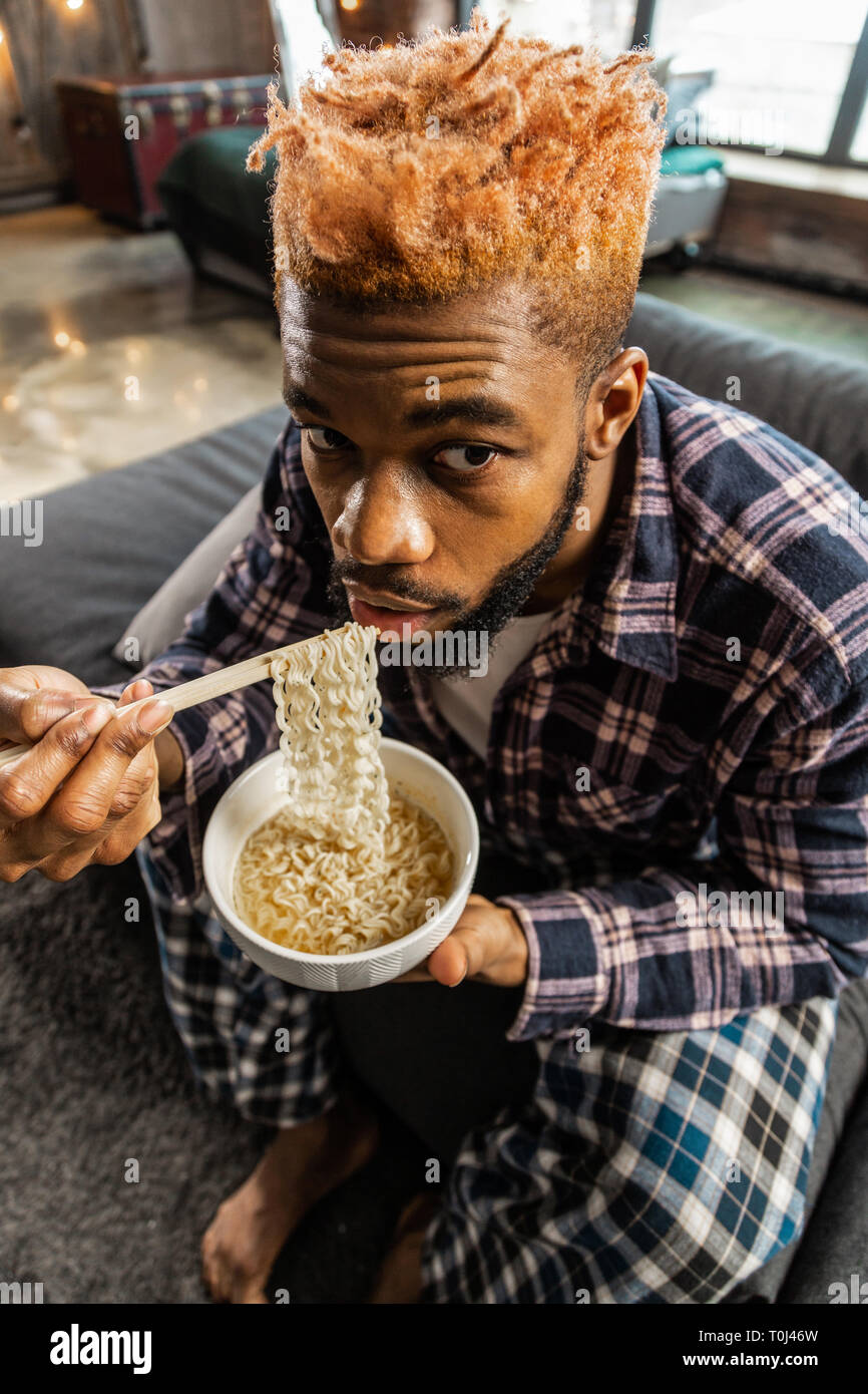 Top view of a pleasant young man using wooden sticks Stock Photo - Alamy