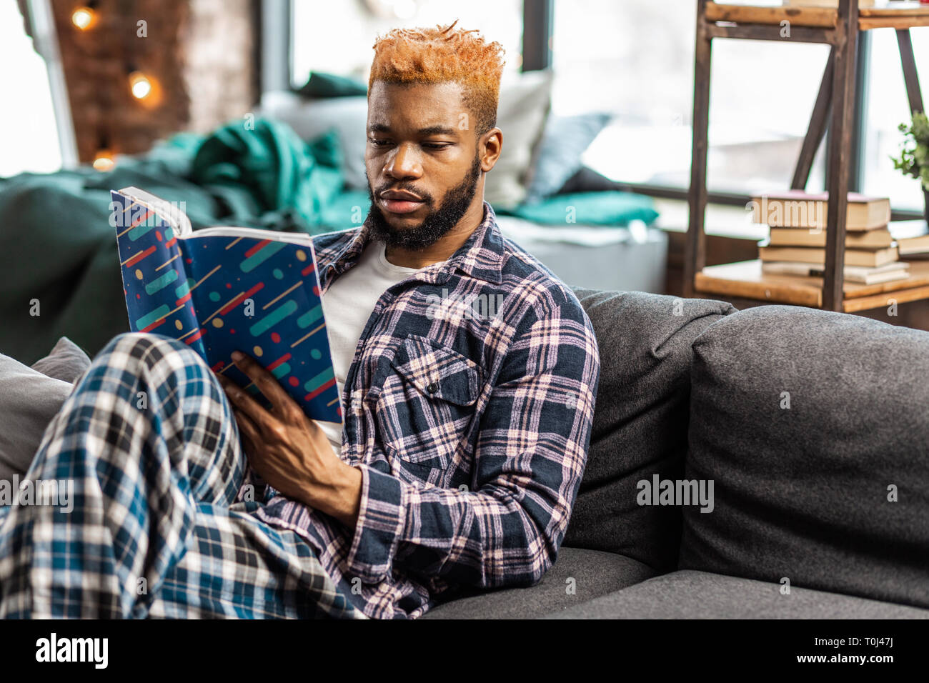 Smart good looking man looking into the book Stock Photo - Alamy