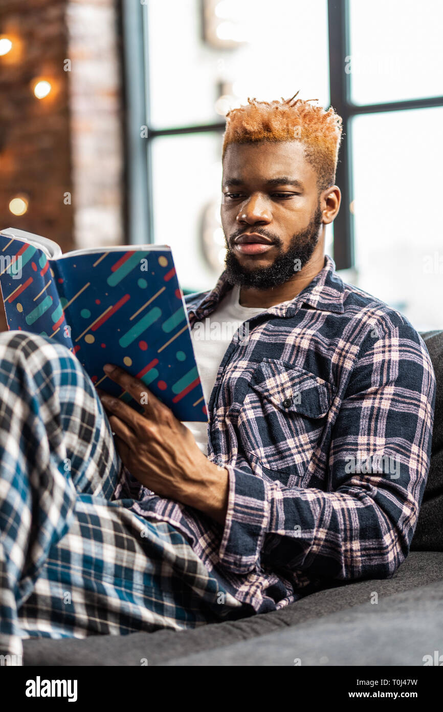Nice smart man getting new knowledge from the book Stock Photo - Alamy