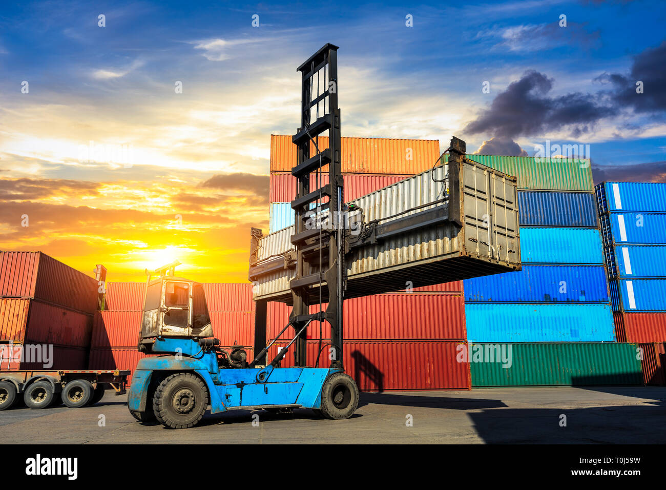 Forklift container loading and unloading cargo into the import-export ...