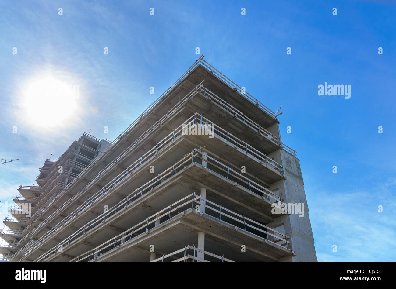 Corner of unfinished concrete multystorey building or parking lot ...