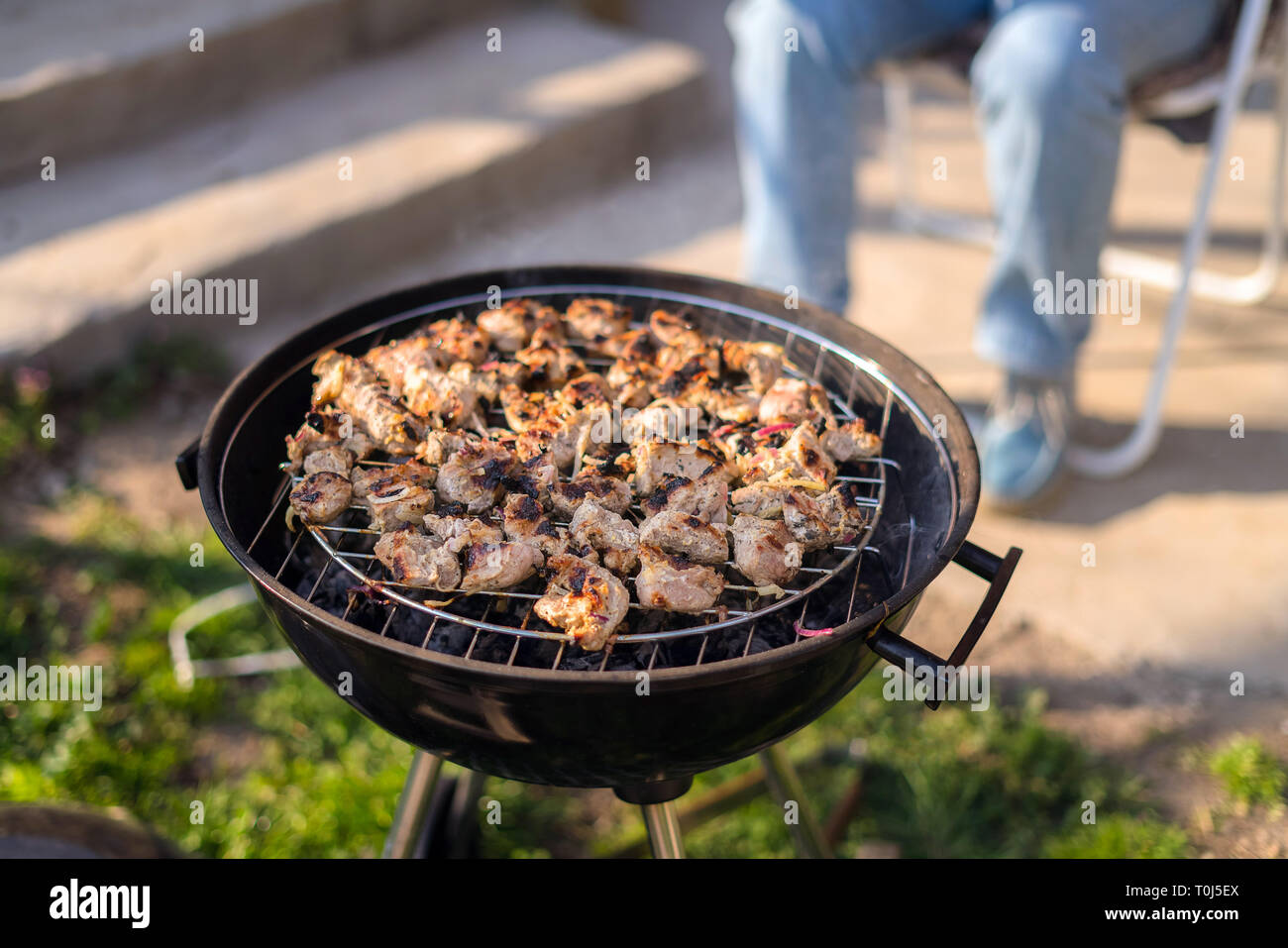 Grilling barbeque meet on the grill outdoors in the back yard. Summer ...