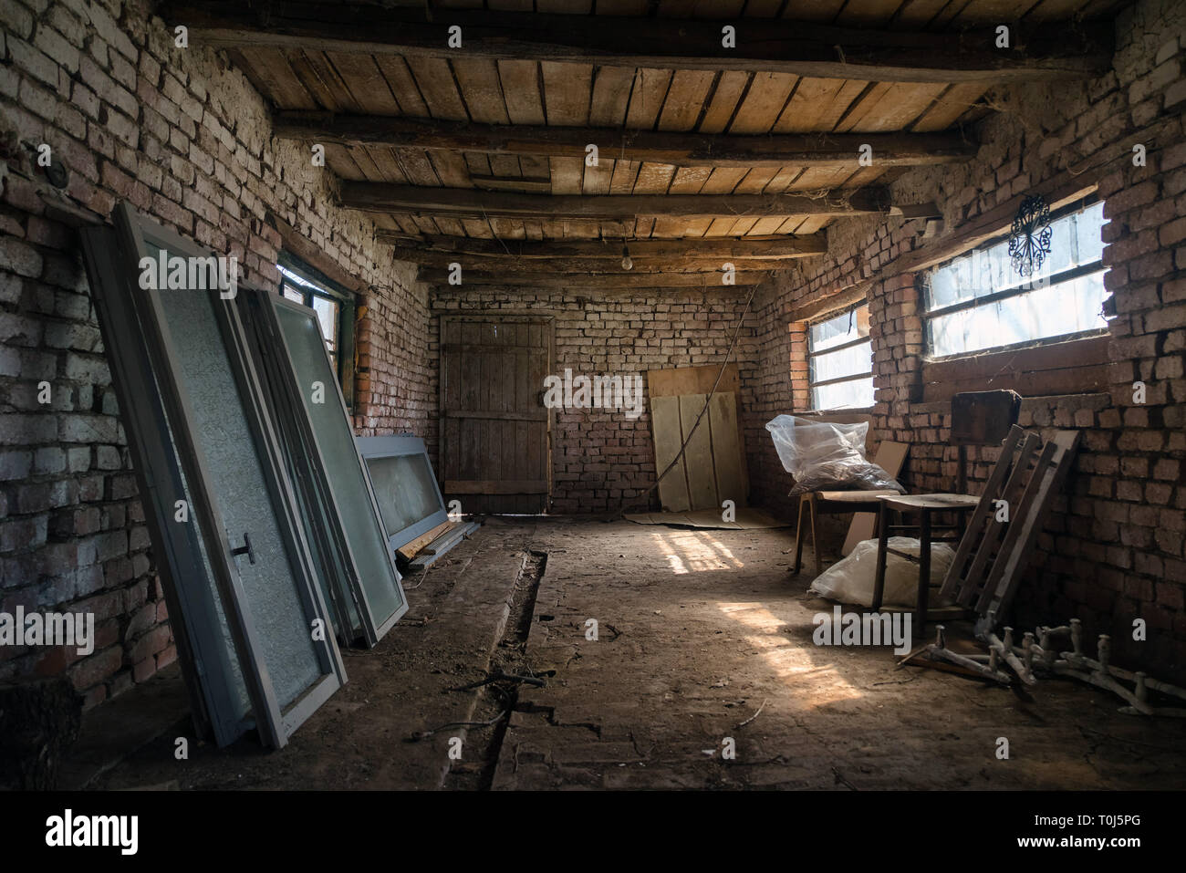 Old barn interior in the village. Vintage shed built of wood and brick ...