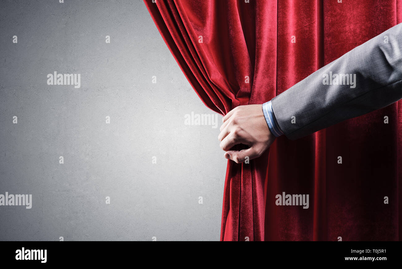 Concrete wall behind drapery curtain and hand opening it Stock Photo ...