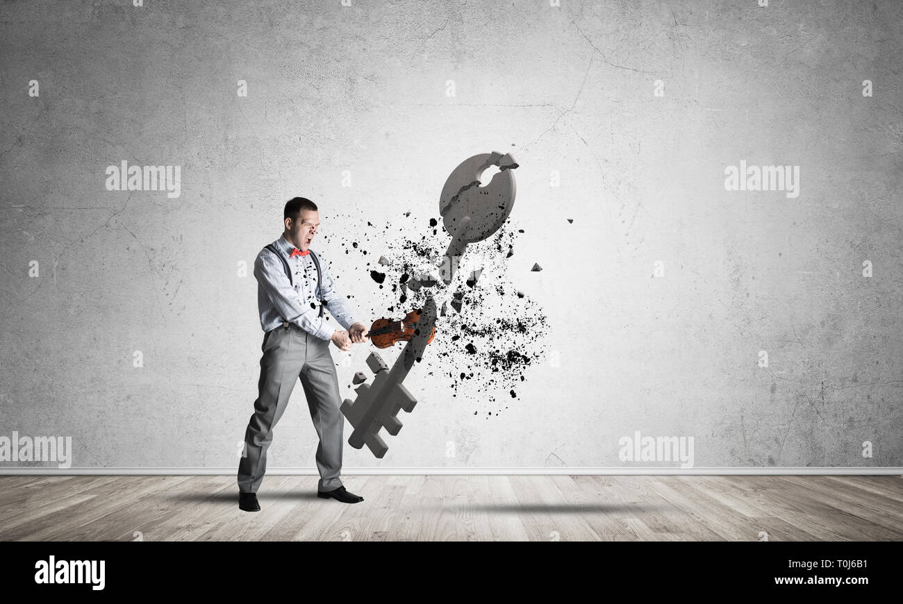 Breaking through access concept with man in room crashing concrete key ...